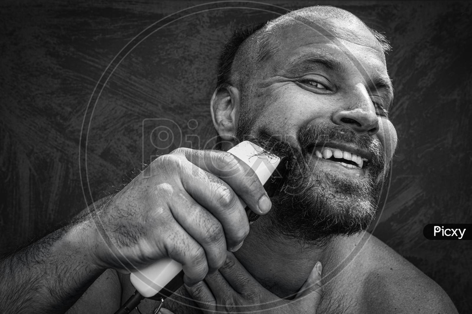 Image of Caucasian Man Trying To Shave With An Electric Razor. A Brutal ...