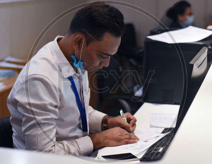 Image of Male receptionist doing his work at hospital reception in ...