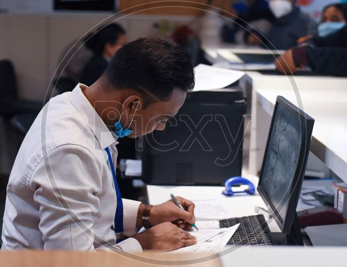 Image of Male receptionist doing his work at hospital reception in ...