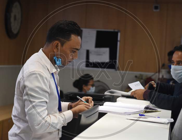 Image of Male receptionist doing his work at hospital reception in ...