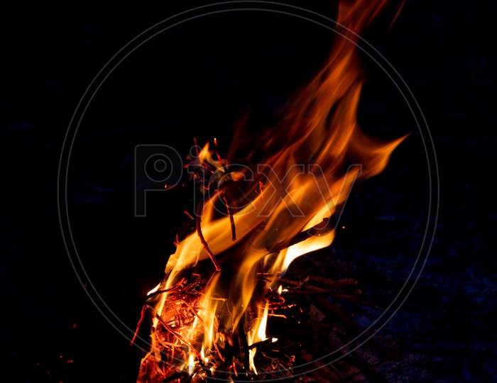 Image of Shiny burning fire in the dark shows the romantic side of a ...