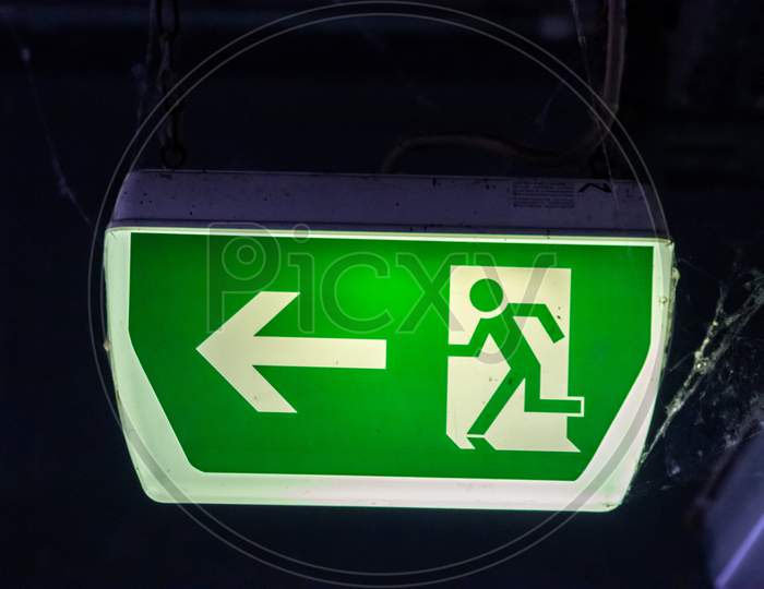 Image of Green exit sign with running person and green arrow shows ...