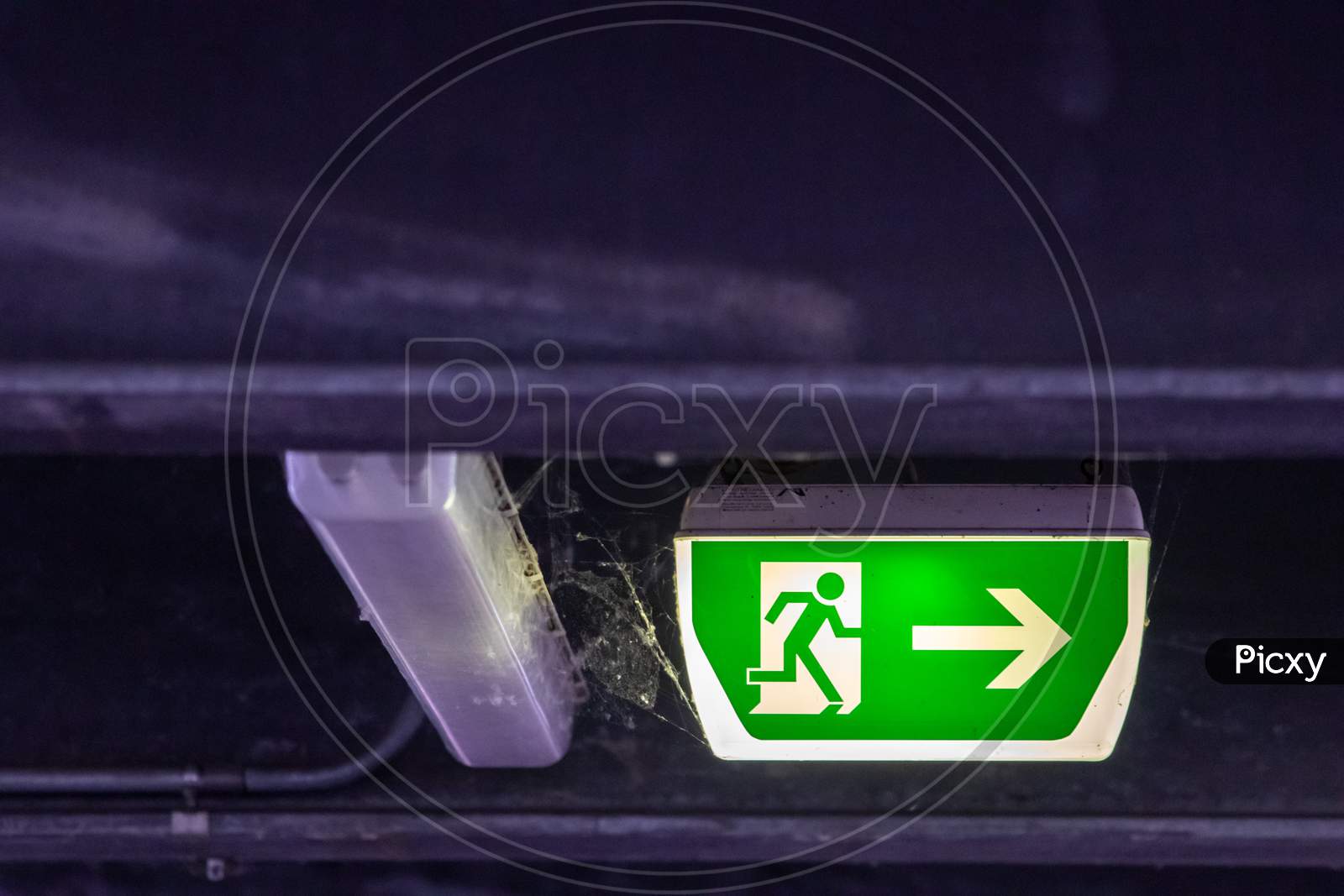 Image of Green exit sign with running person and green arrow shows ...