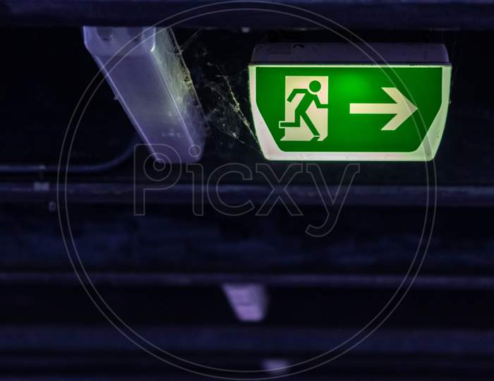 Image of Green exit sign with running person and green arrow shows ...