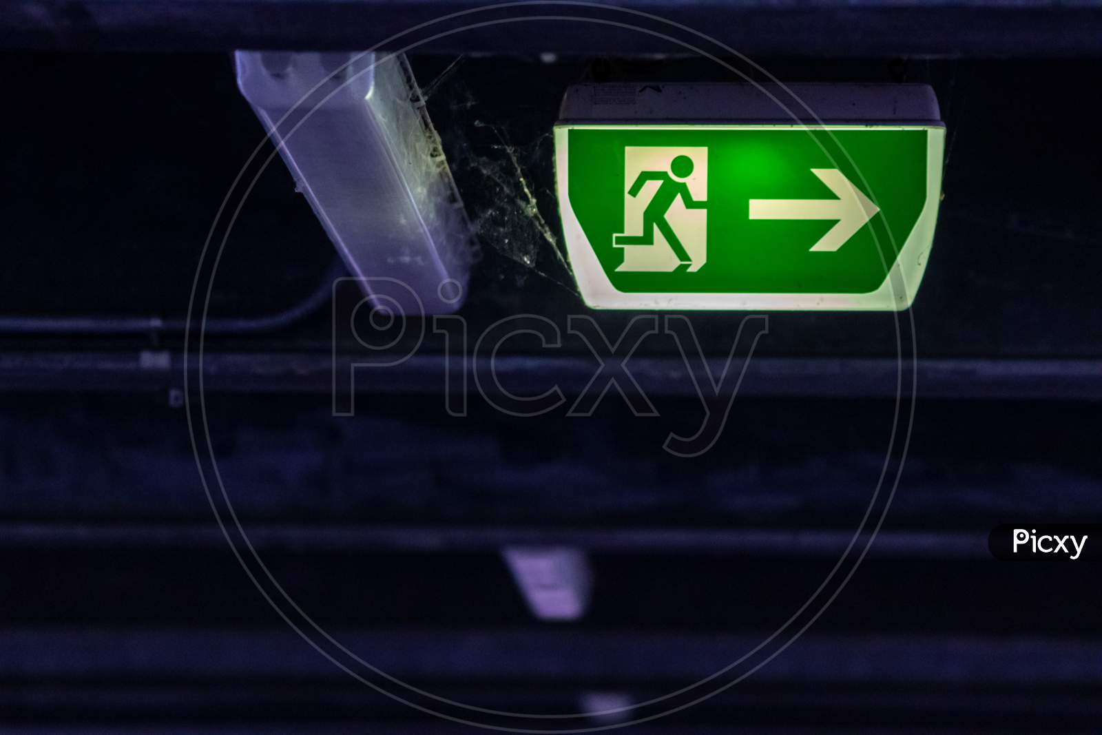 Image of Green exit sign with running person and green arrow shows ...