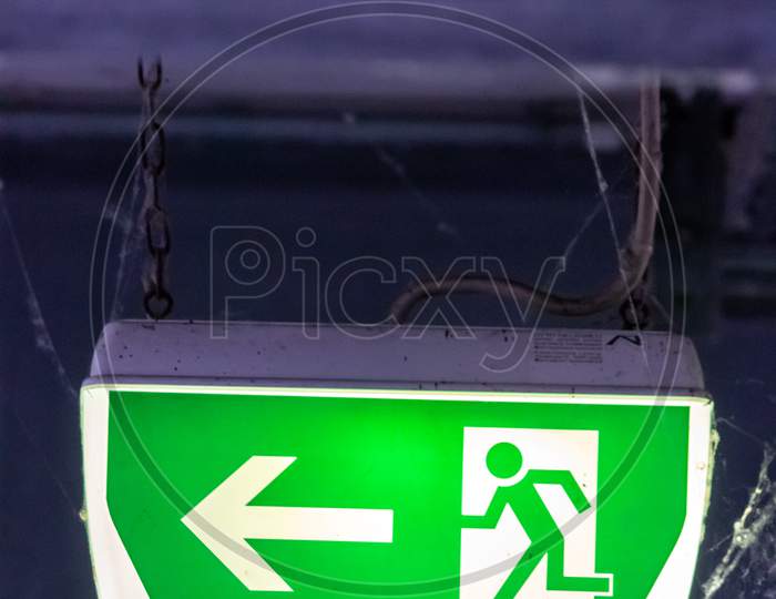 Image of Green exit sign with running person and green arrow shows ...