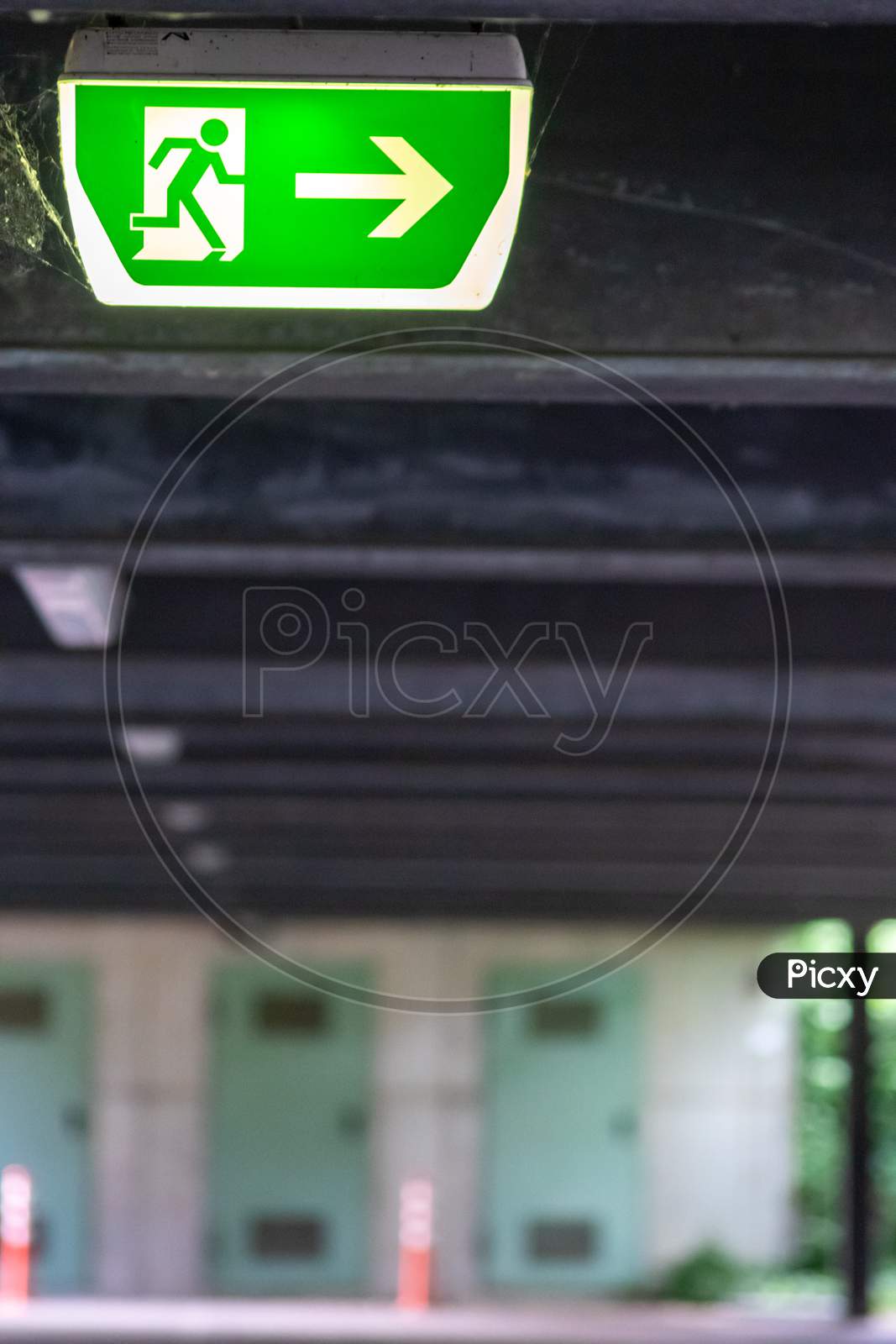 Image of Green exit sign with running person and green arrow shows ...