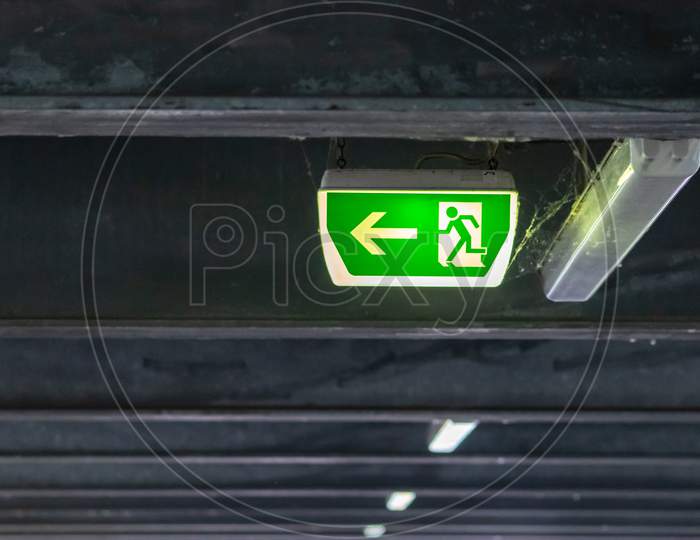 Image of Green exit sign with running person and green arrow shows ...