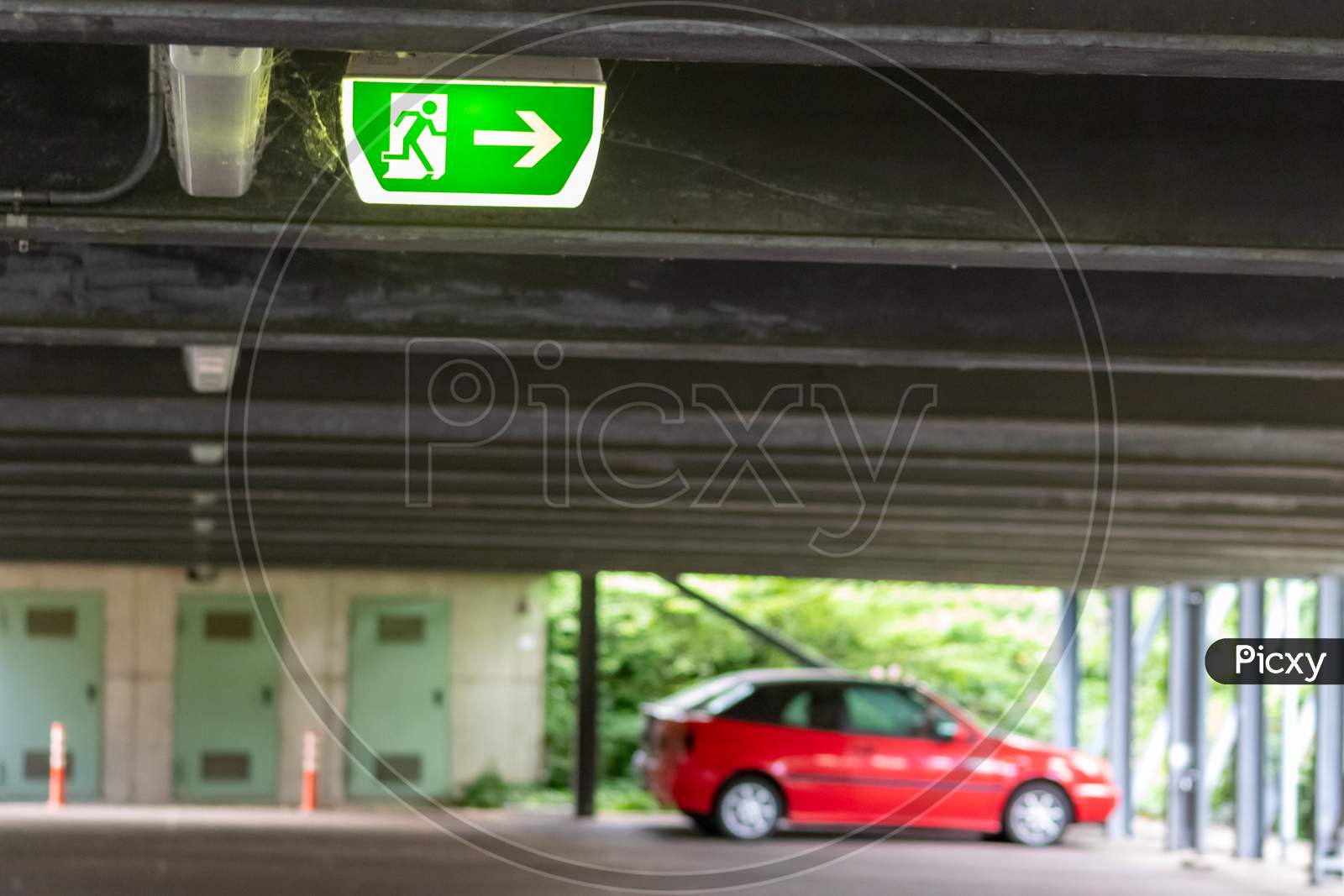 Image of Green exit sign with running person and green arrow shows ...