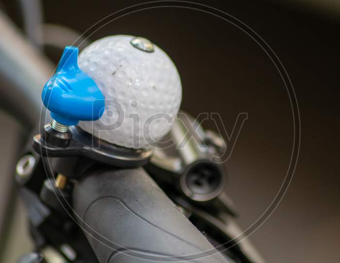 Image of Beautiful golf ball and club bike bell ensures security in the ...