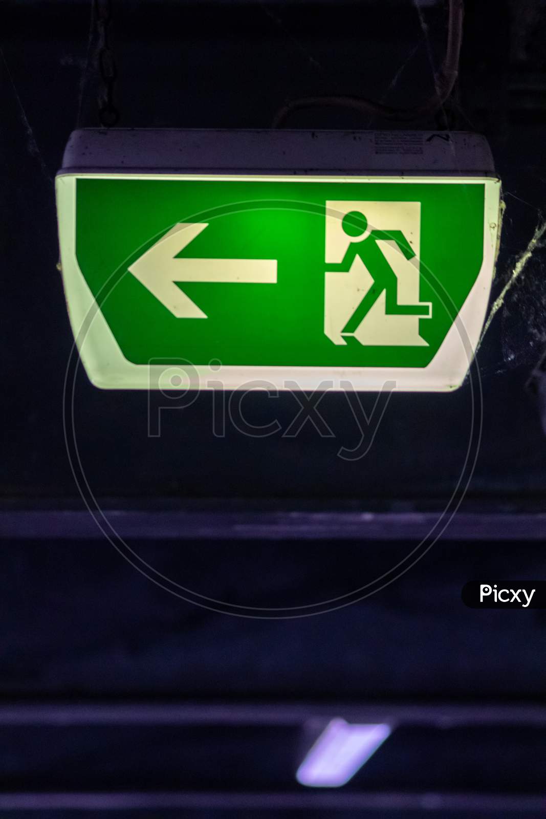 Image of Green exit sign with running person and green arrow shows ...