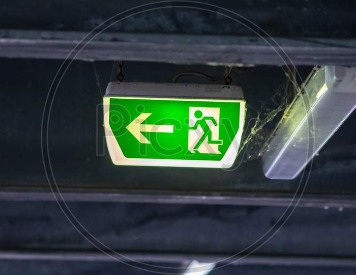 Image of Green exit sign with running person and green arrow shows ...