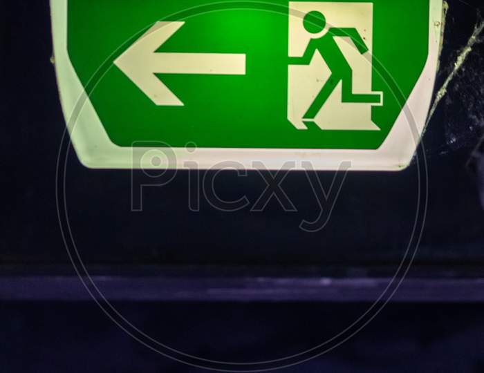 Image of Green exit sign with running person and green arrow shows ...