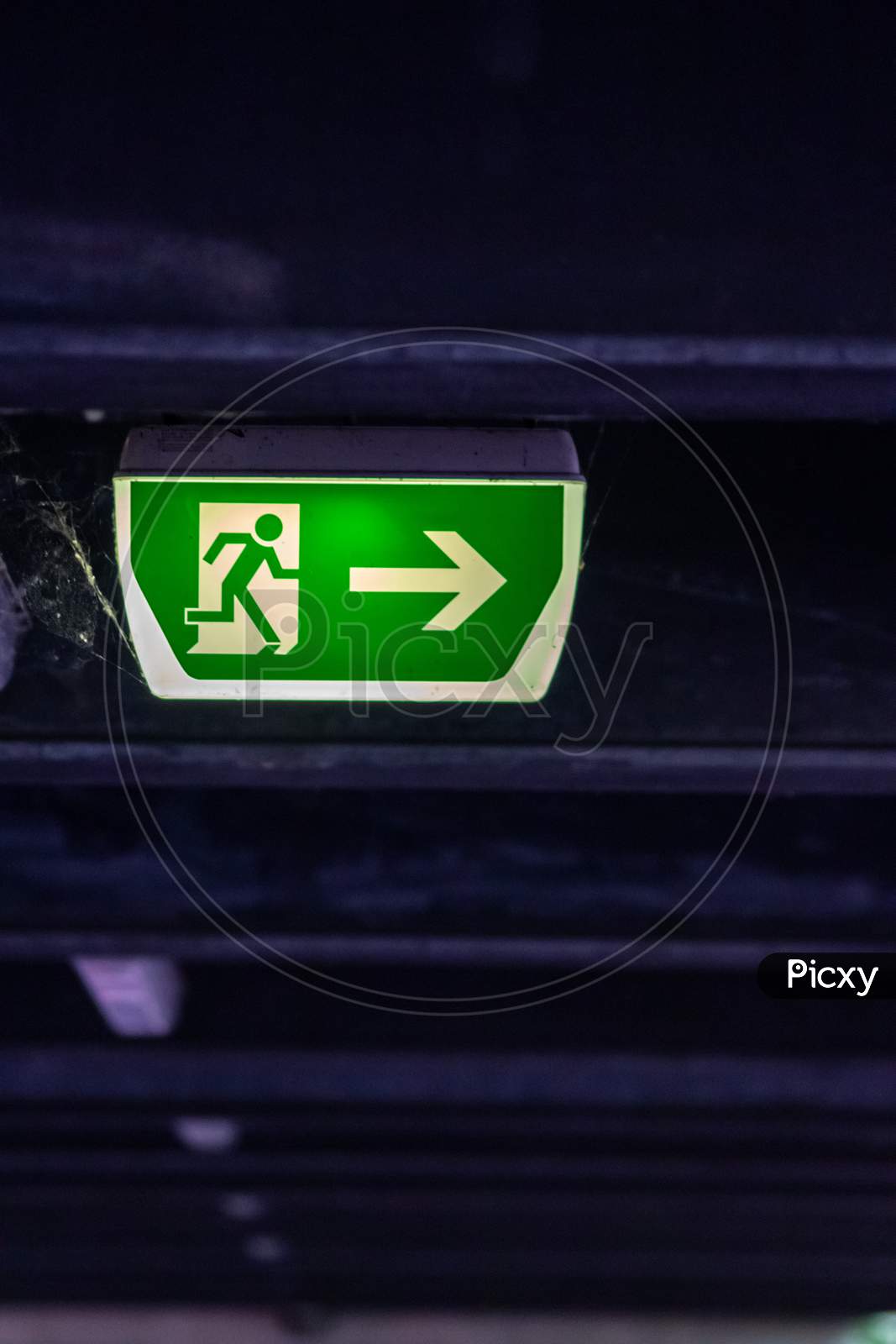 Image of Green exit sign with running person and green arrow shows ...