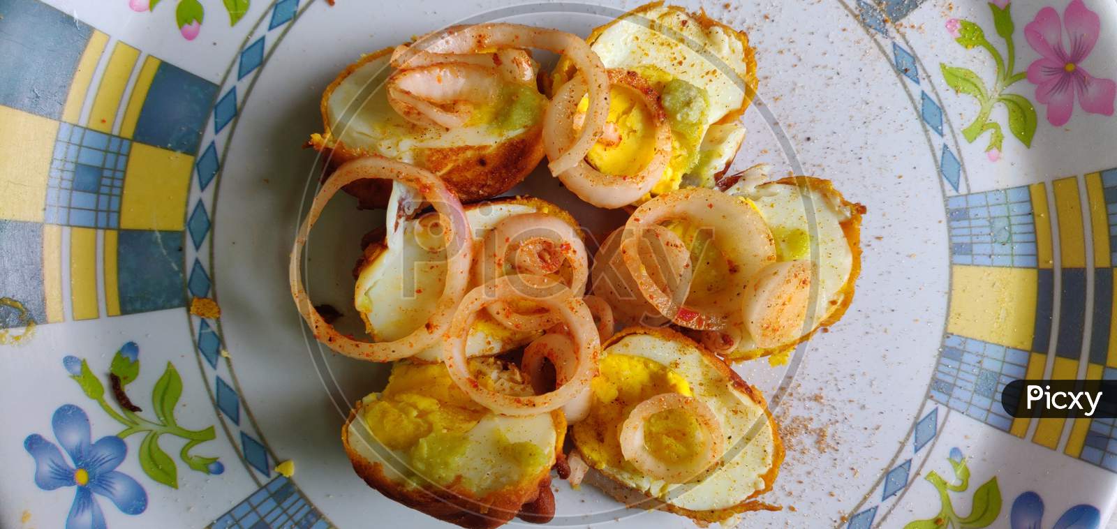 Image of Egg Pakoda or pakora garnished with spices and onions are ...