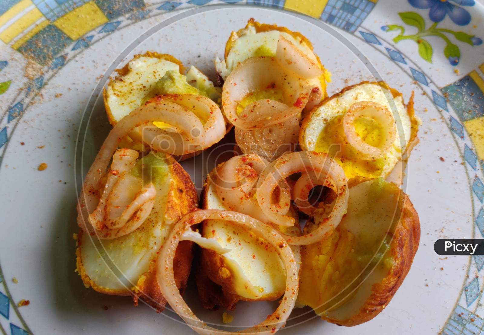 Image of Egg Pakoda or pakora garnished with spices and onions are ...