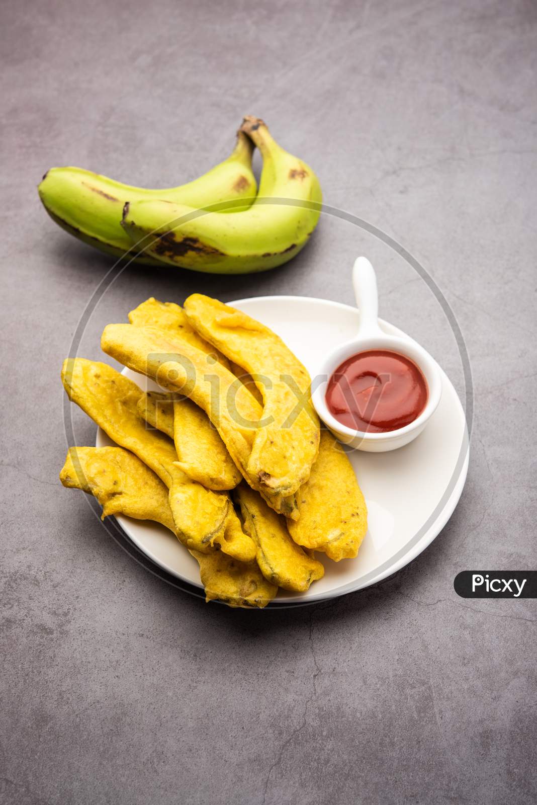 Image of Banana Fritter Or Pakora Or Raw Kela Pakoda Or Bajji Served ...