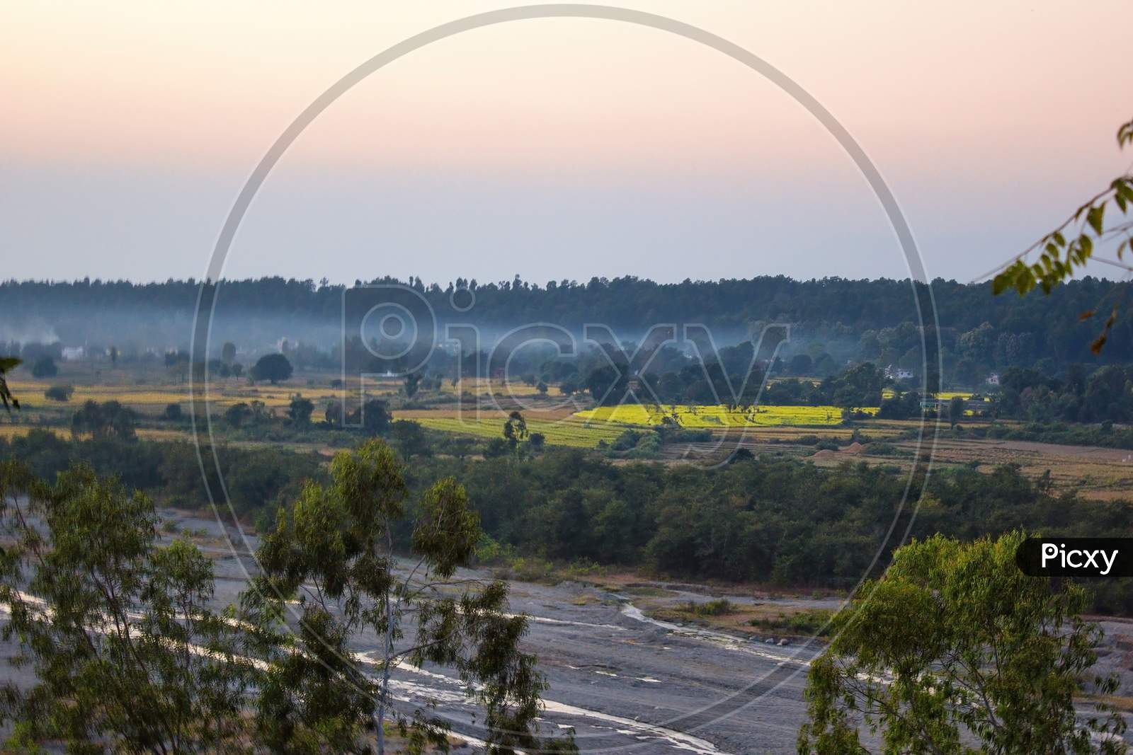 Image of Wide Angle View Of Grass Field And Tons River In The Mountain ...