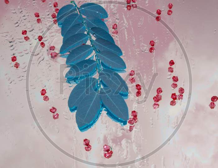 Image of Leaves Turquoise Color Presentation With Red Crystal On Glass ...