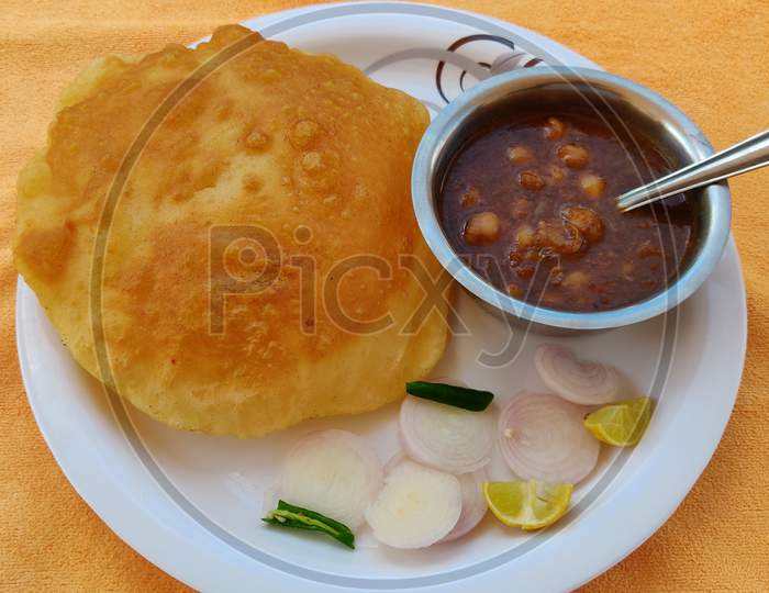 Image of Indian Popular breakfast Chola bhatura with Onion served on ...