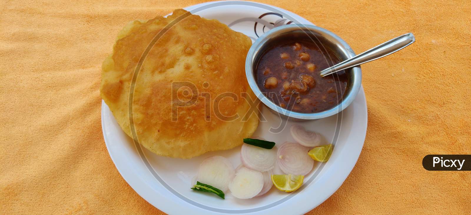 Image of Indian Popular breakfast Chola bhatura with Onion served on ...