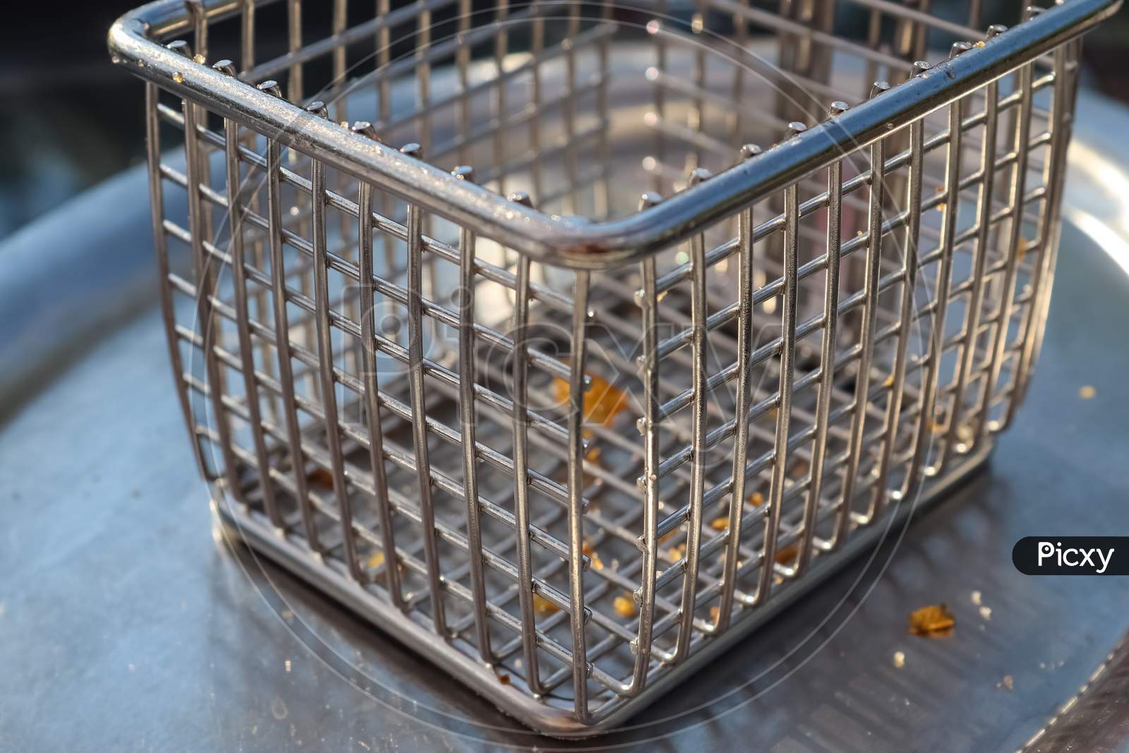 Image of Empty Metallic Deep Fryer On A Table With Some Little Fries ...