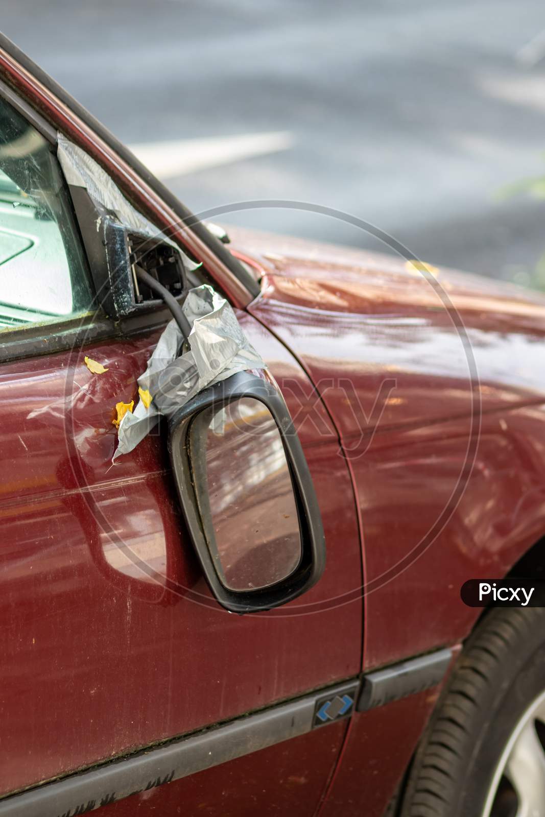 Image of Broken side mirror hanging at a demolished car after car ...