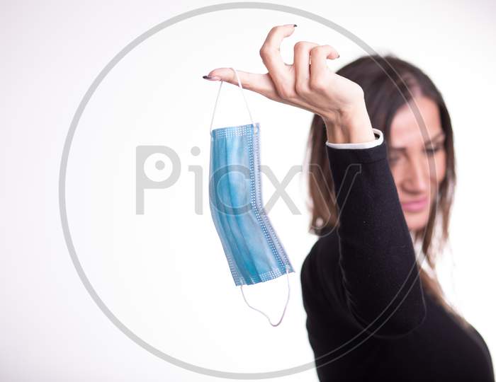 Image of Happy Woman Takes Off Medical Protective Mask Holds It On Her ...