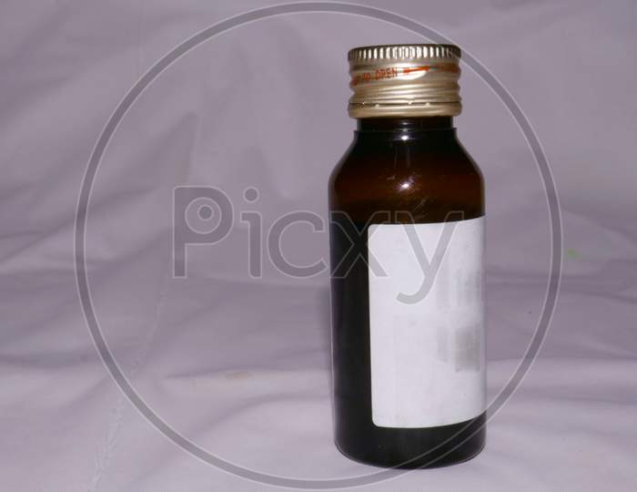Image of Opened Cap Medicine Bottle Displayed On Leaves Green Field ...
