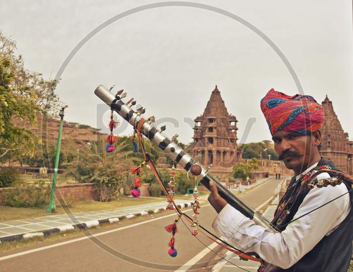Image of Gypsy musician playing tumbi instrument-DG278737-Picxy