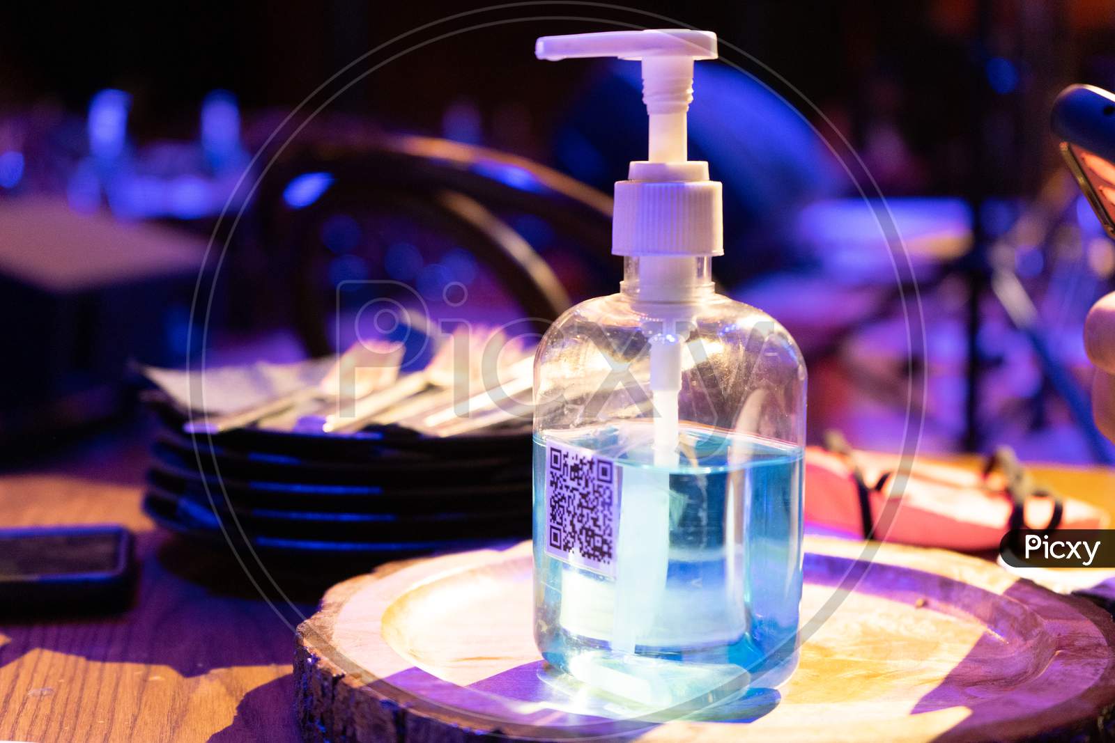 Image of Sanitizer Bottle With Qr Code For Digital Menu Being Scanned ...