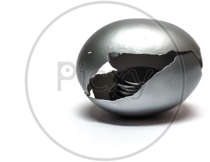 Image of Closeup of Broken silver egg with coins inside isolated in a ...