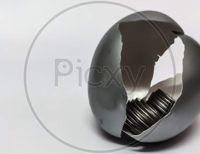 Image of Closeup of Broken silver egg with coins inside isolated in a ...