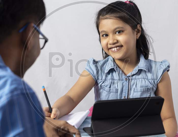 Image of Indian Girl Child Studying With Tablet Beside Her Teacher ...