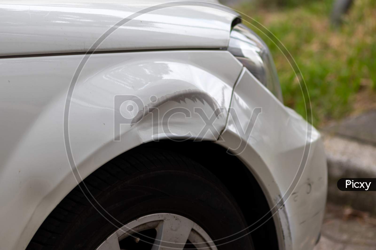 Image of Dented car wing and fender with scratches and bumps after ...