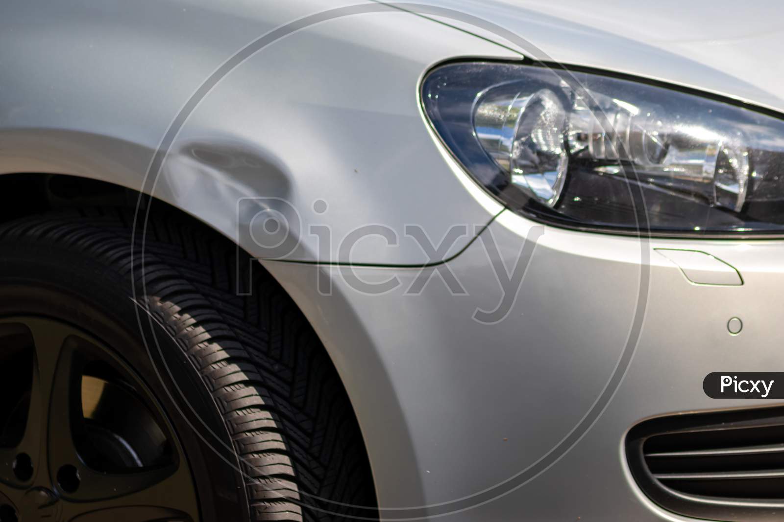 Image of Dented car wing and fender with scratches and bumps after ...