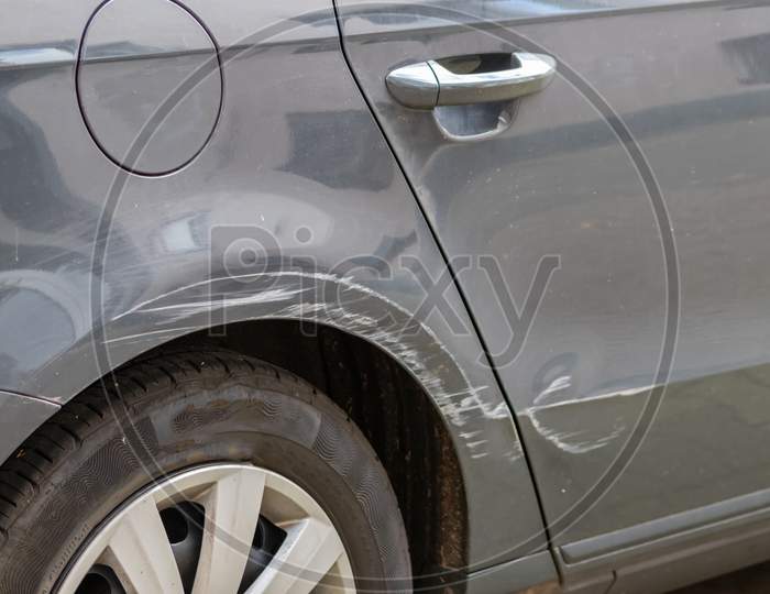Image of Dented car wing and fender with scratches and bumps after ...