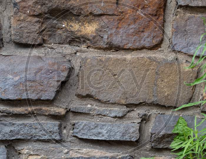 Image of Massive stone wall with rough rocks like a castle wall with different bricks as natural ...