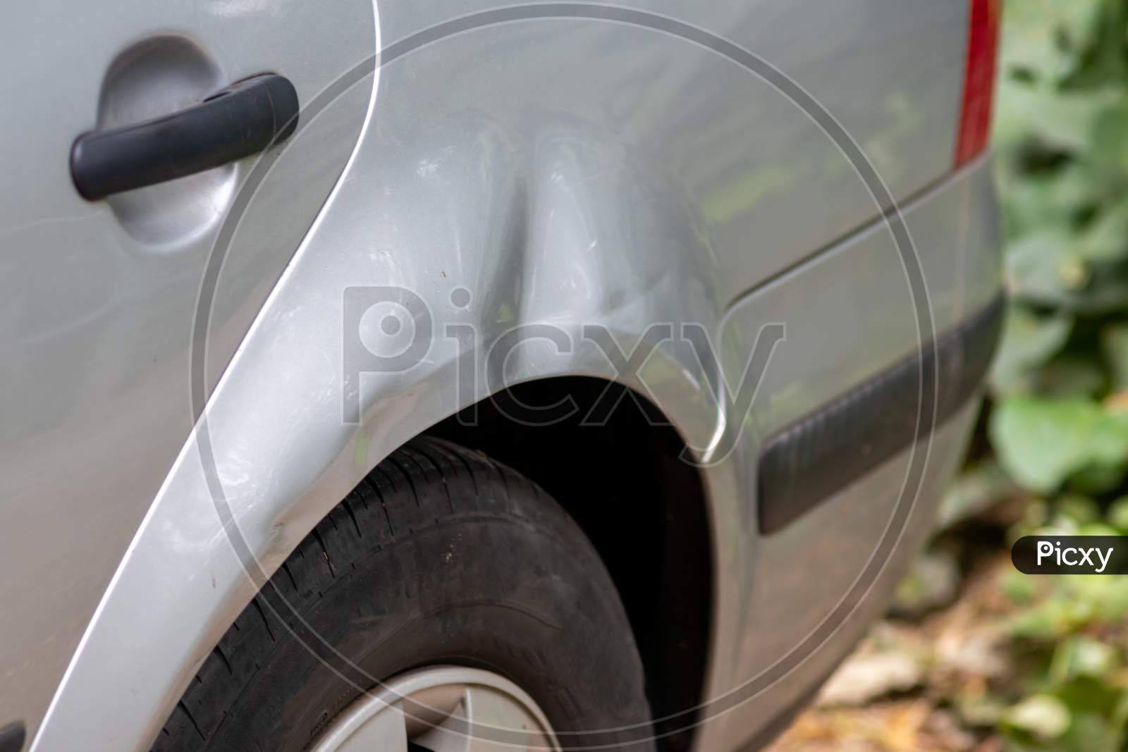 Image of Dented car wing and fender with scratches and bumps after ...