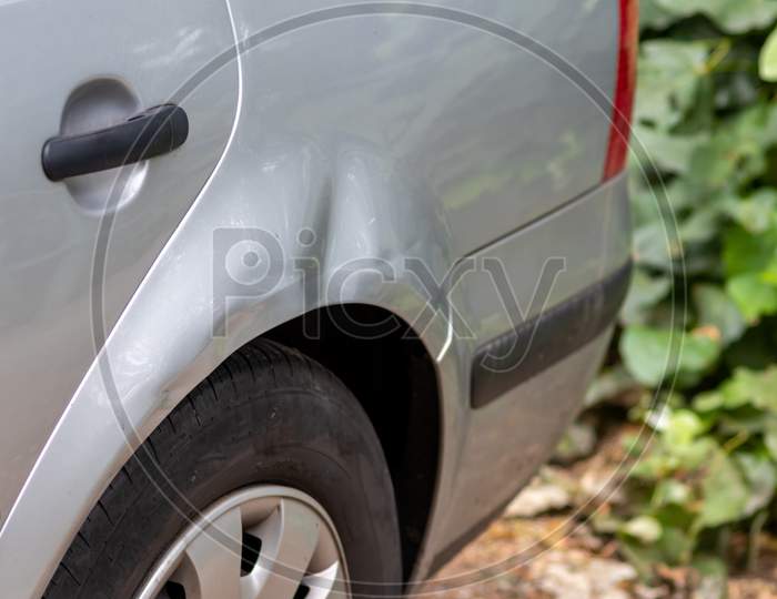 Image of Dented car wing and fender with scratches and bumps after ...