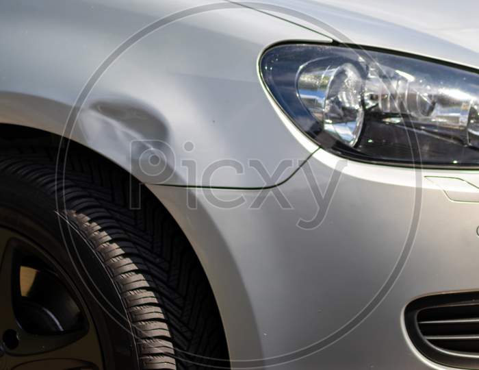 Image of Dented car wing and fender with scratches and bumps after ...