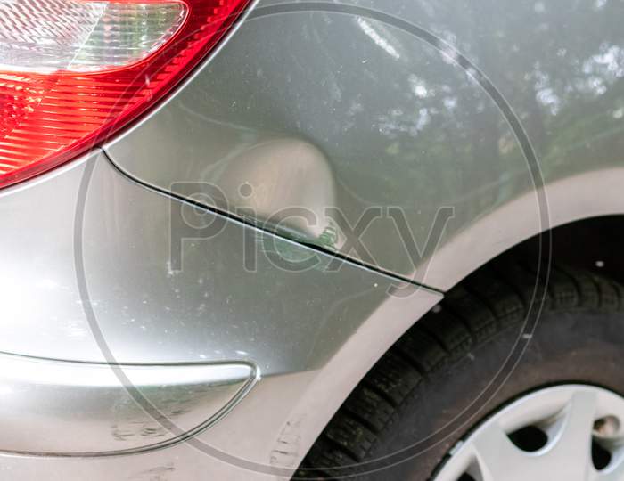 Image of Dented car wing and fender with scratches and bumps after ...