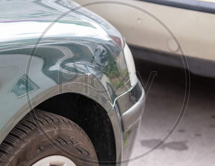 Image of Dented car wing and fender with scratches and bumps after ...