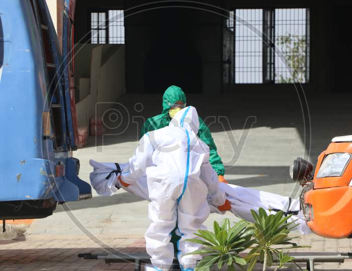 Image of Removing Covid Deadbody from Ambulance for last ritual-LD344448-Picxy