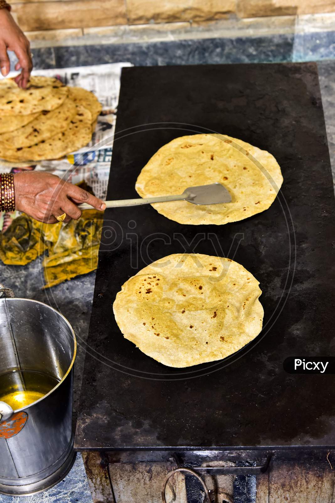 Image of Indian Food Chapati Roti Making In Wedding Ceremony-DY749058-Picxy