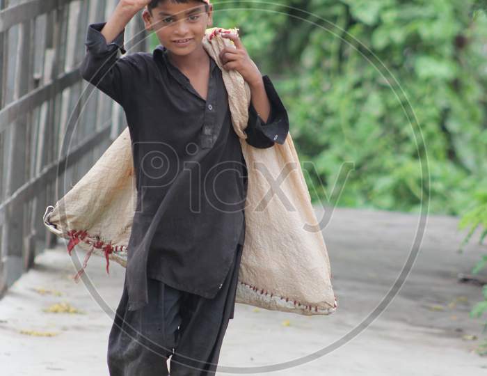 Image of A Boy Carrying A Garbage Bag To Sell, The Lives And Lifestyles ...