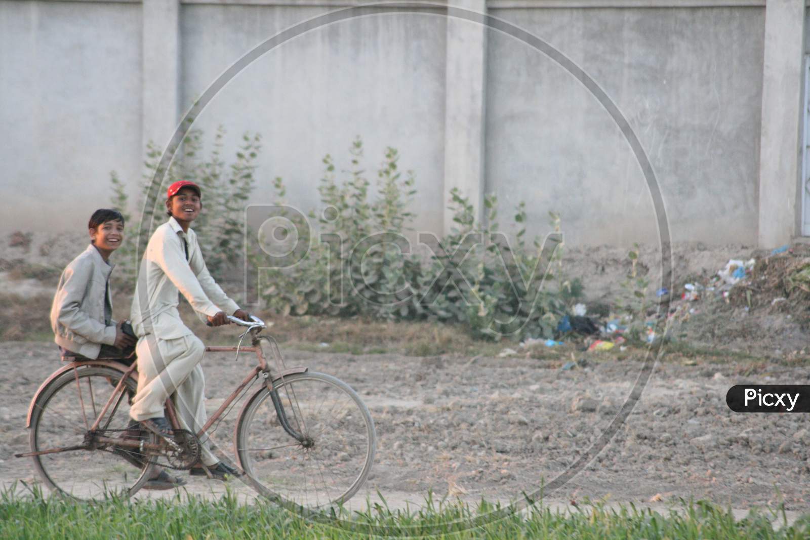 Image of A view of an villager kids going on bicycle in an sindh ...