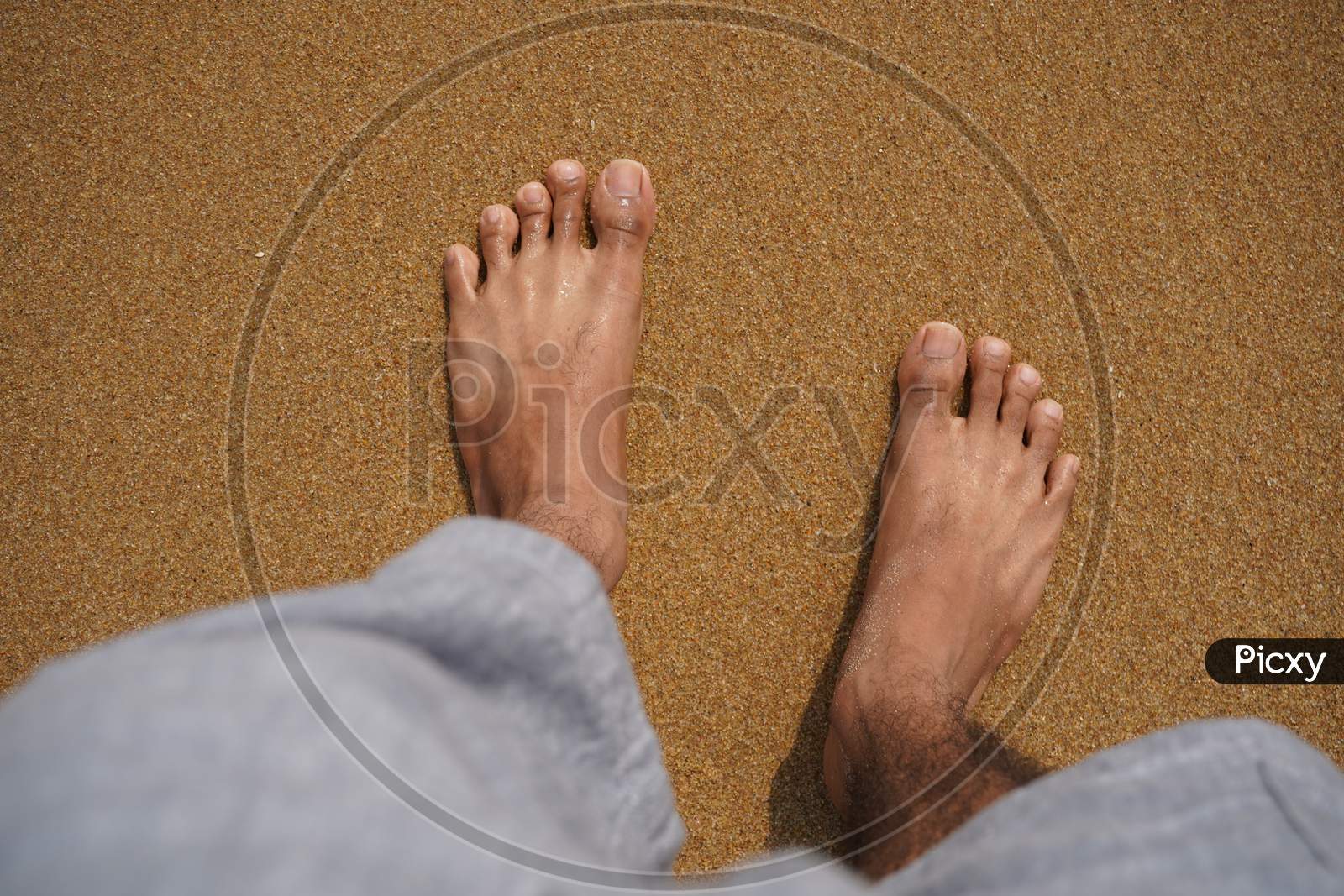 Image of Close up of male feet by the beach-HS526690-Picxy
