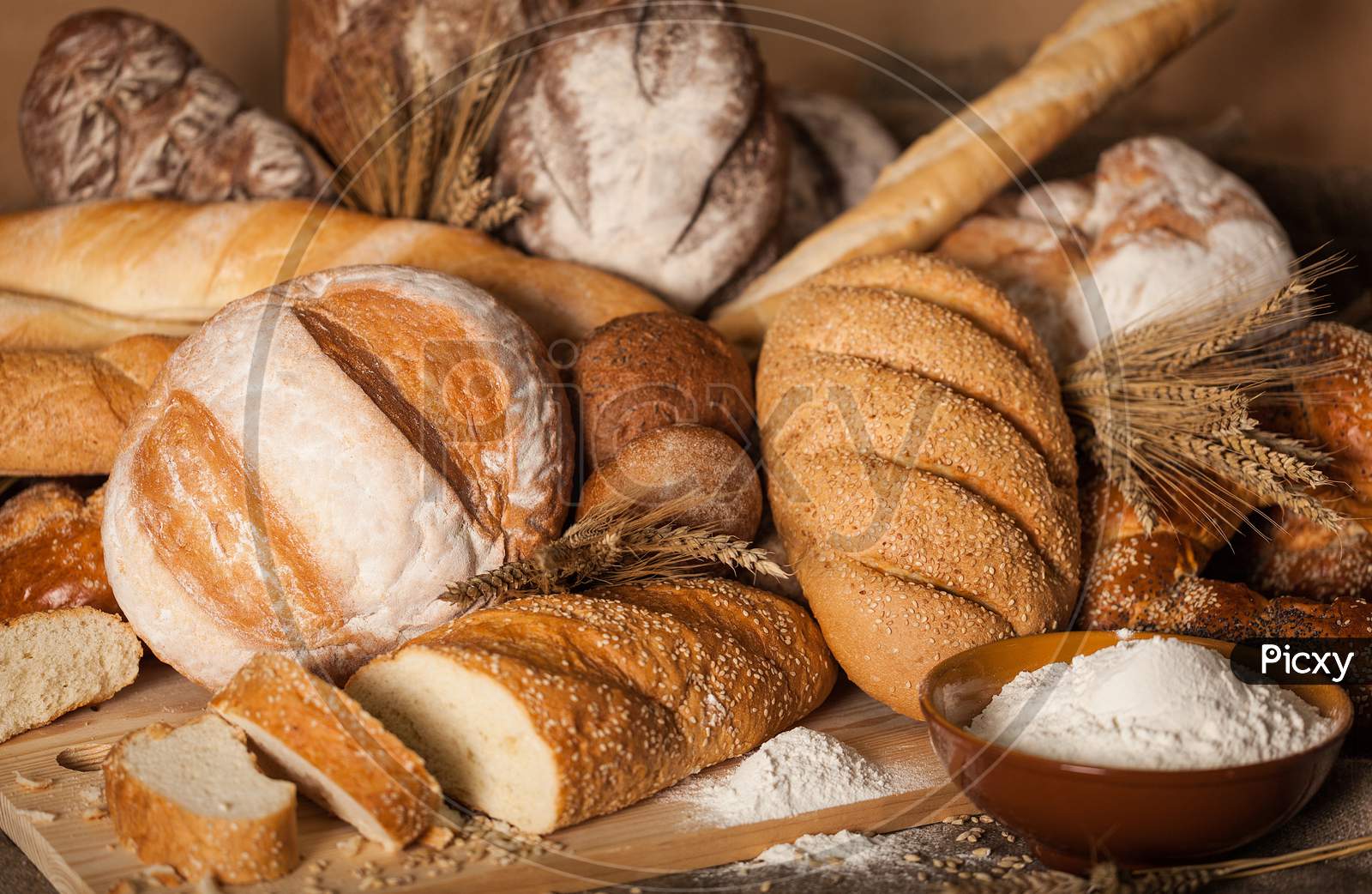 Image of Bread is a staple food prepared from a dough of flour usually ...