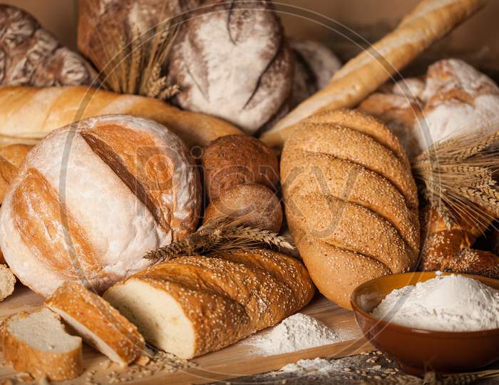 Image of Bread is a staple food prepared from a dough of flour usually ...